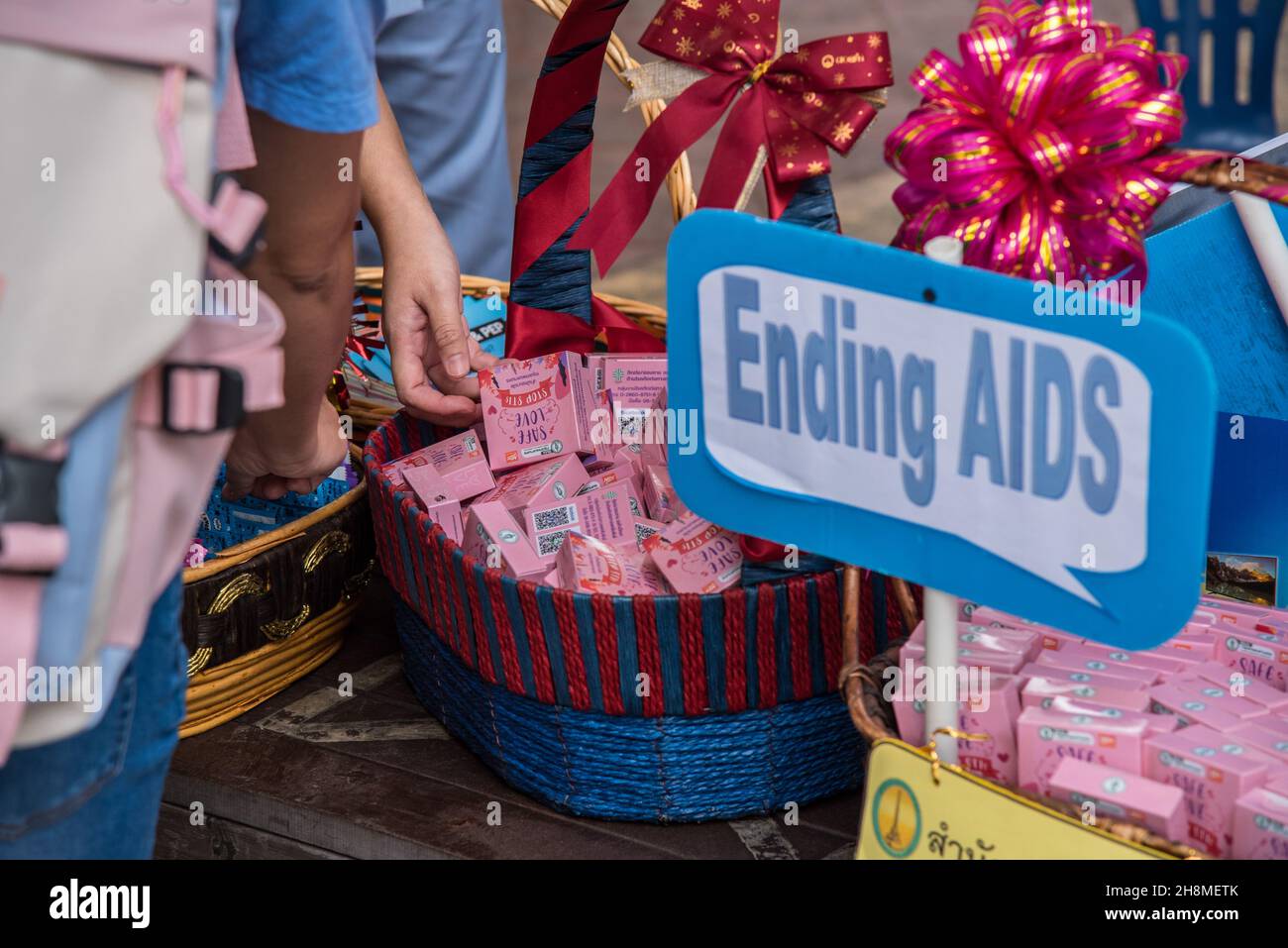 Bangkok, Thailand. 01st Dec, 2021. Baskets seen filled with condoms and a sign reading 'Ending ...