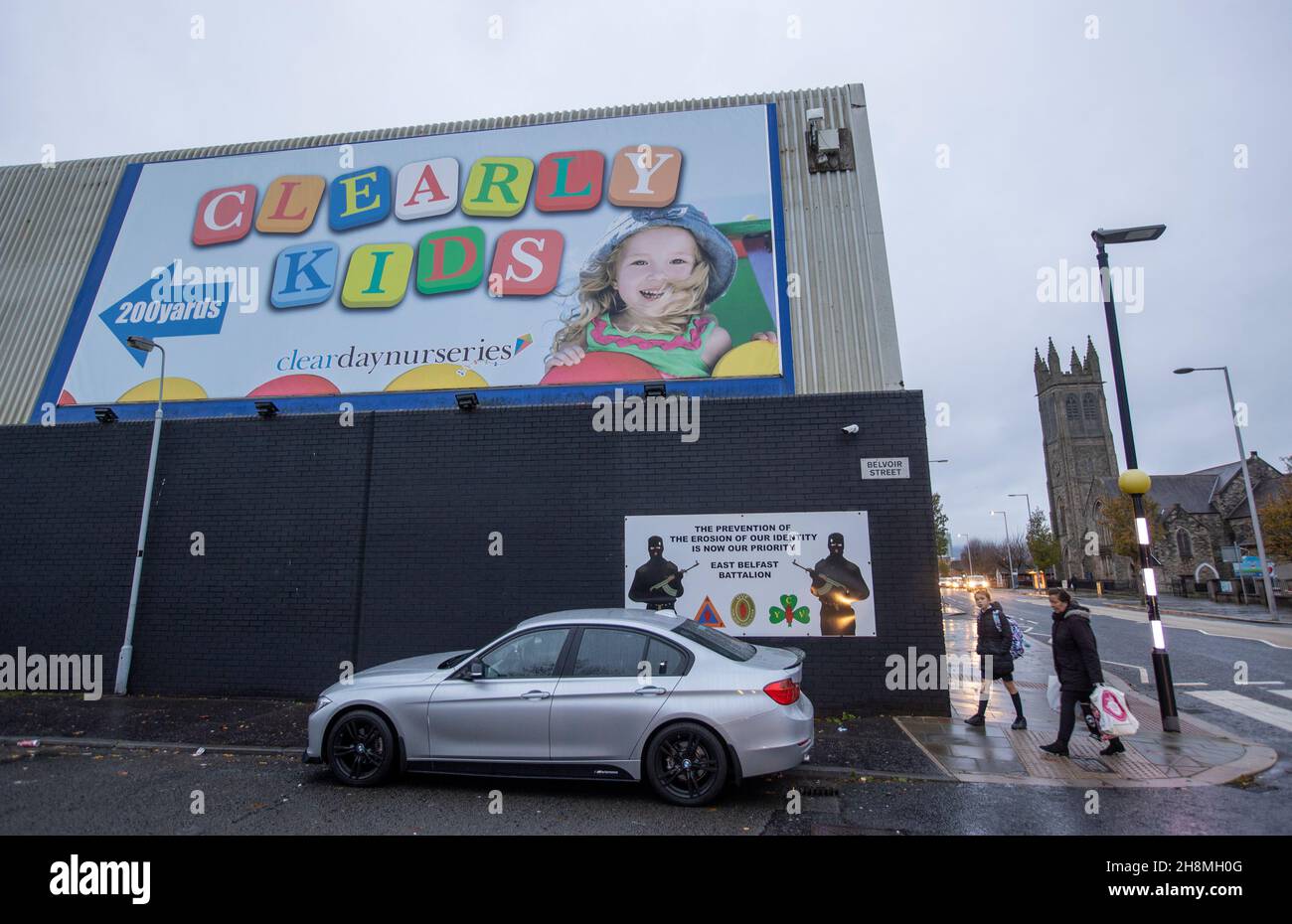 People walk past a banner in support of Ulster loyalist paramilitary ...