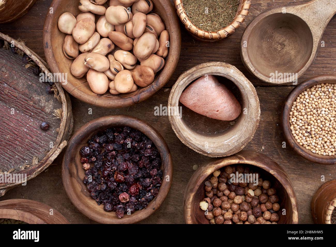 Medieval food in wooden and ceramic dinnerware. Cereals, seeds, dried ...