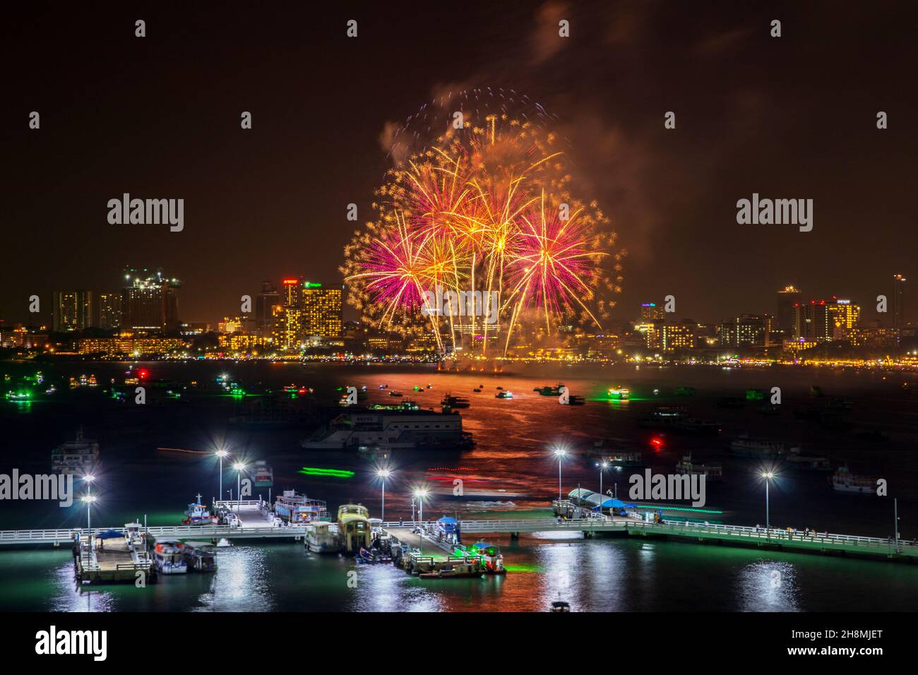 Colorful fireworks display over the night sky of the city during a ...