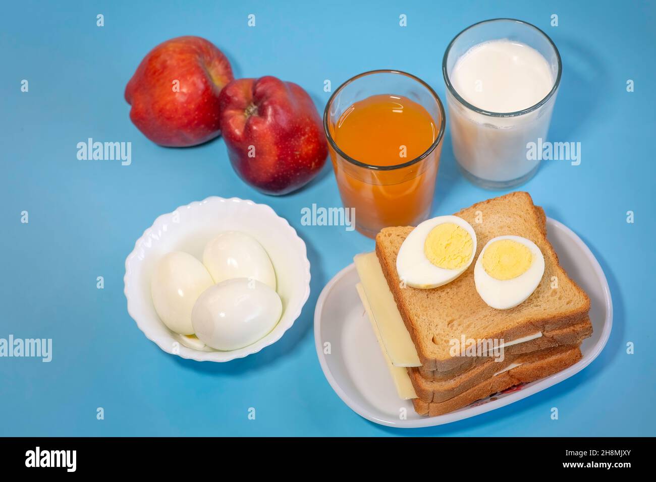 Healthy Indian breakfast with brown bread, cheese and sliced egg with ...