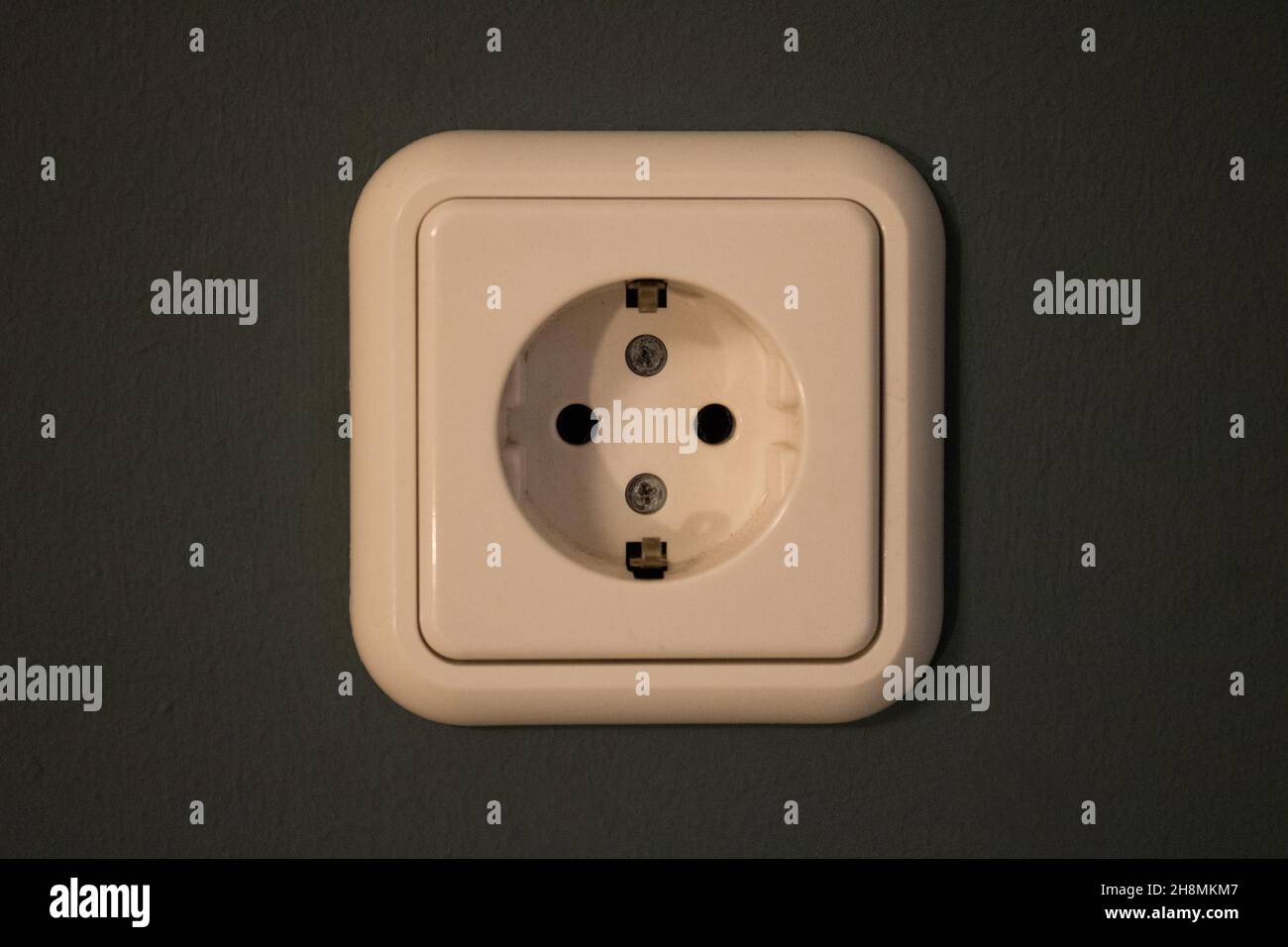a white socket close-up on a blue background Stock Photo - Alamy