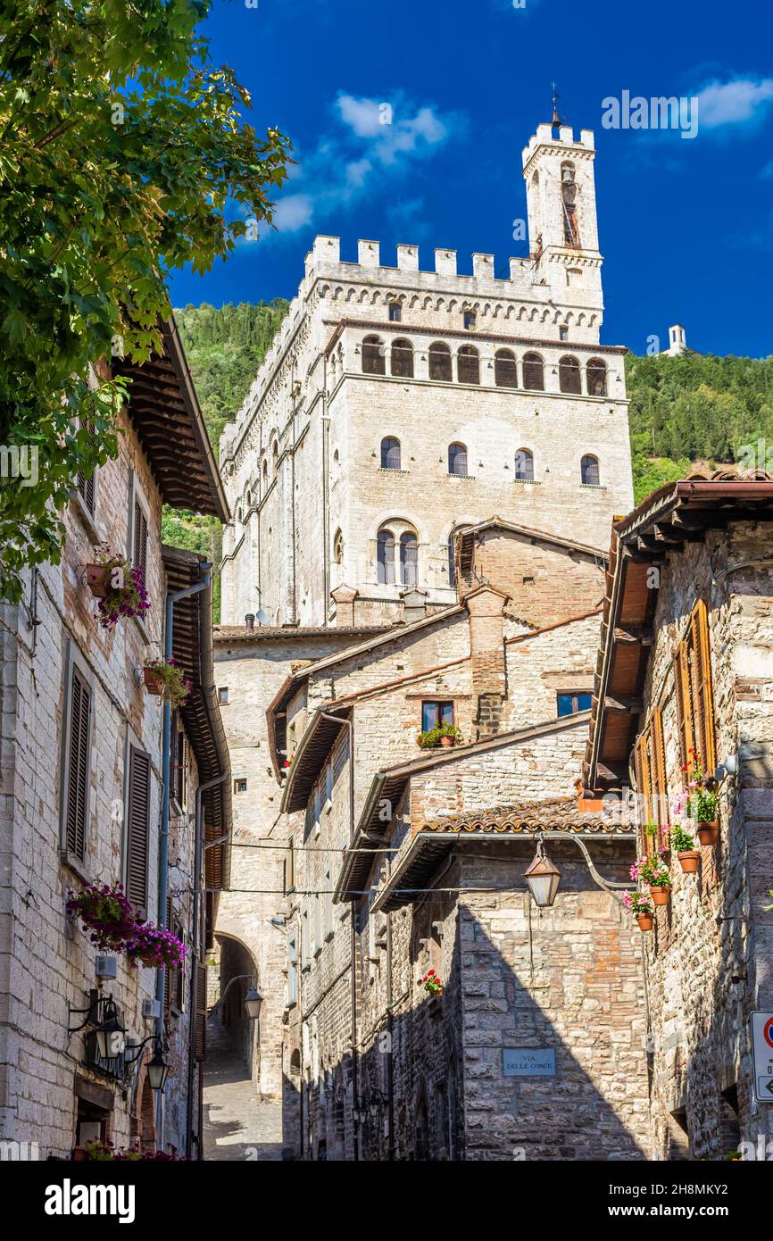 View of the old palace of Gubbio from a medieval street in the historic ...