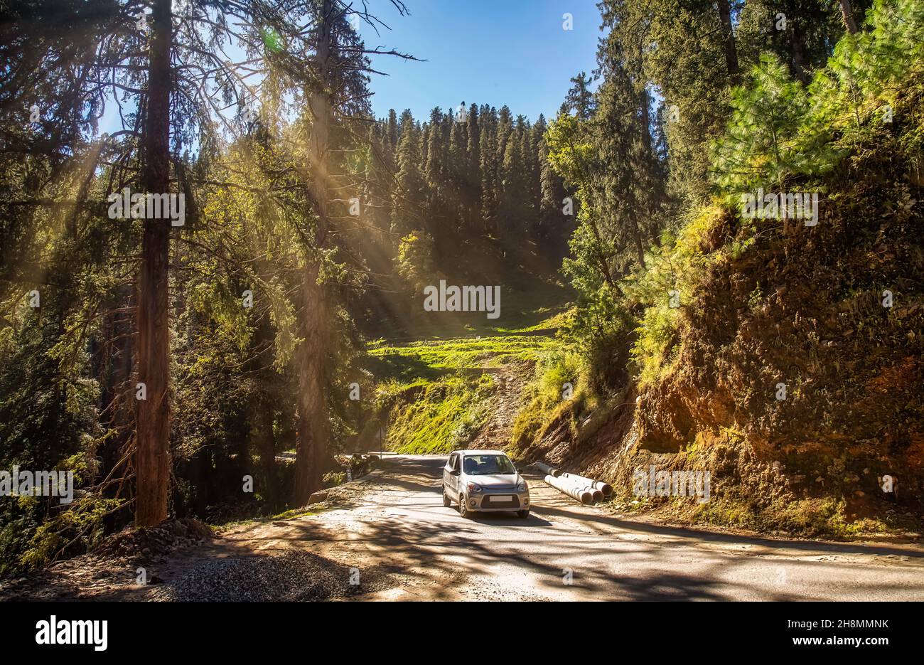 Tourist car driving along national mountain highway road on way to ...