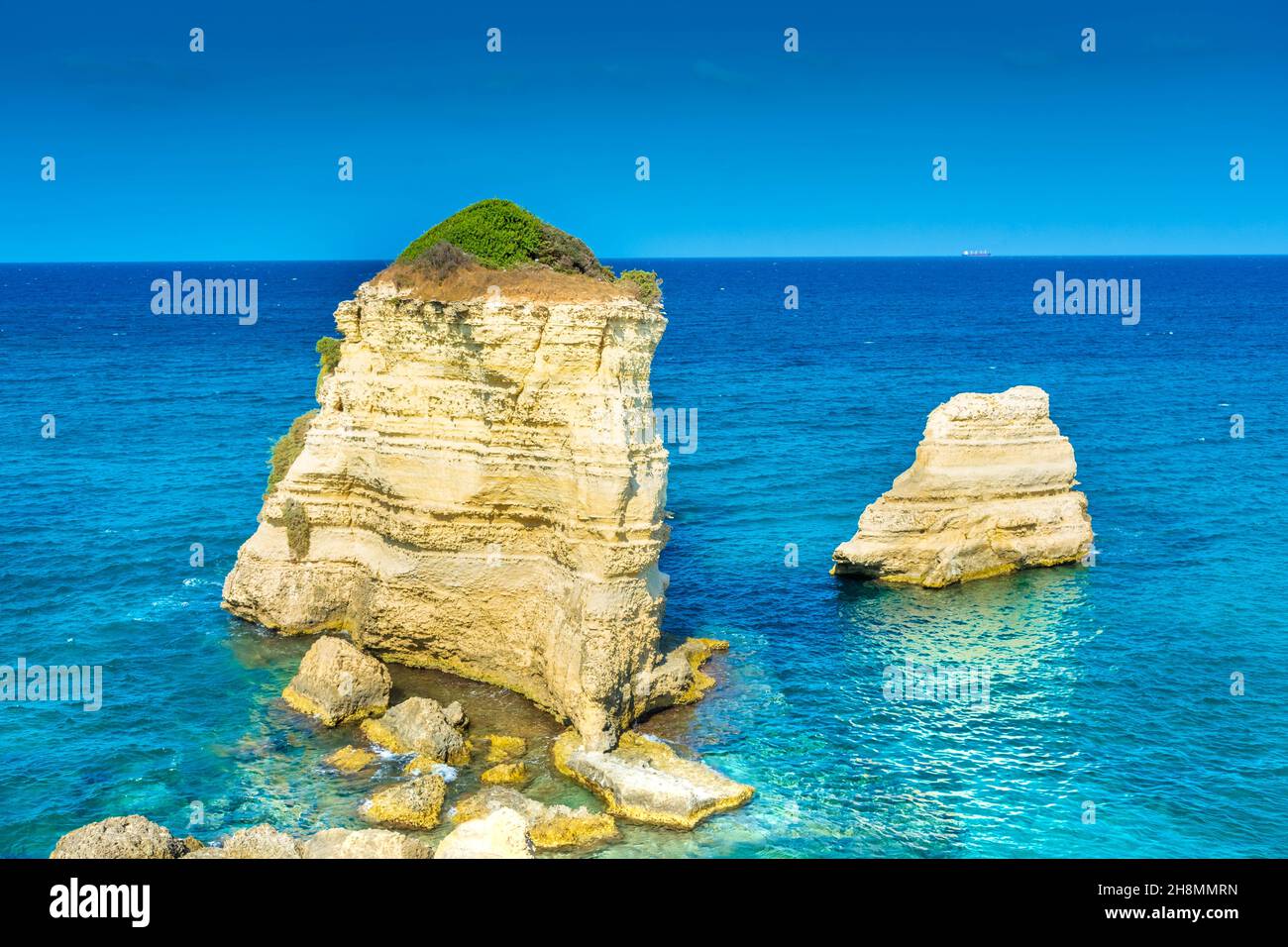 Beautiful cliffs and sea stacks of Sant'Andrea on the crystal clear ...