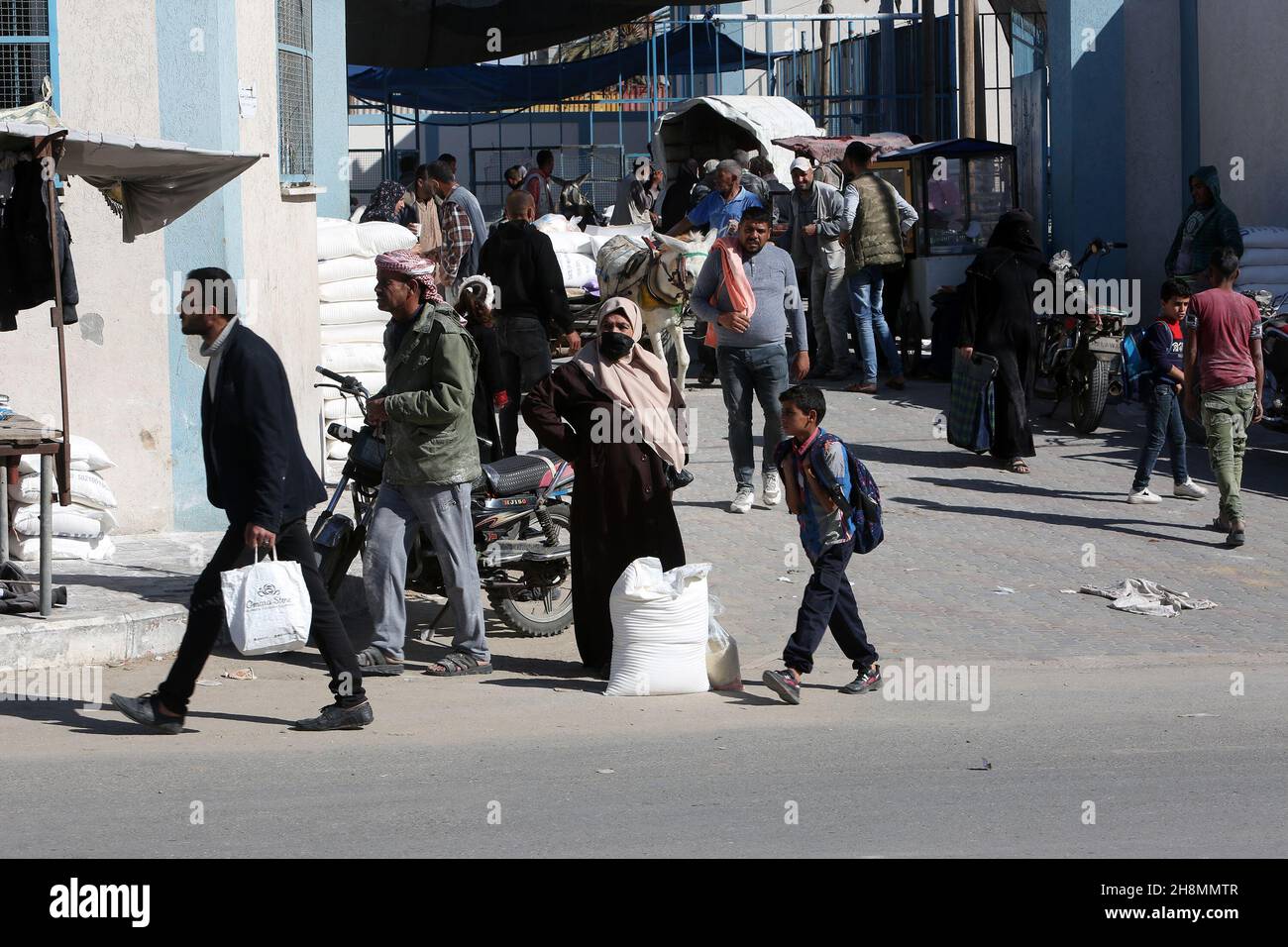 Palestinians receiving food aid for the new cycle from a UN (UNRWA ...