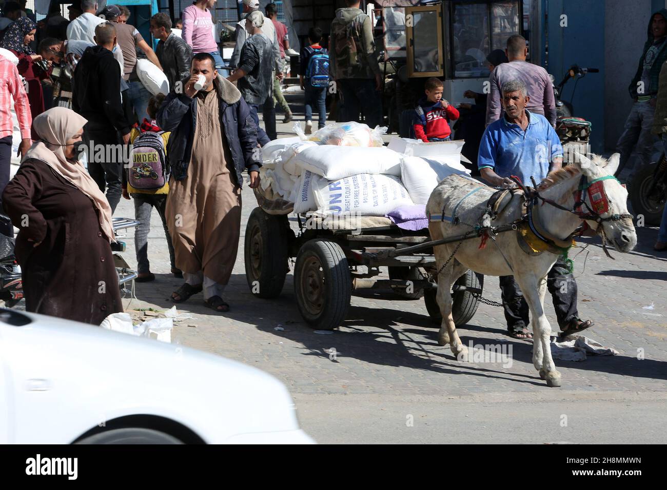 Palestinians receiving food aid for the new cycle from a UN (UNRWA ...