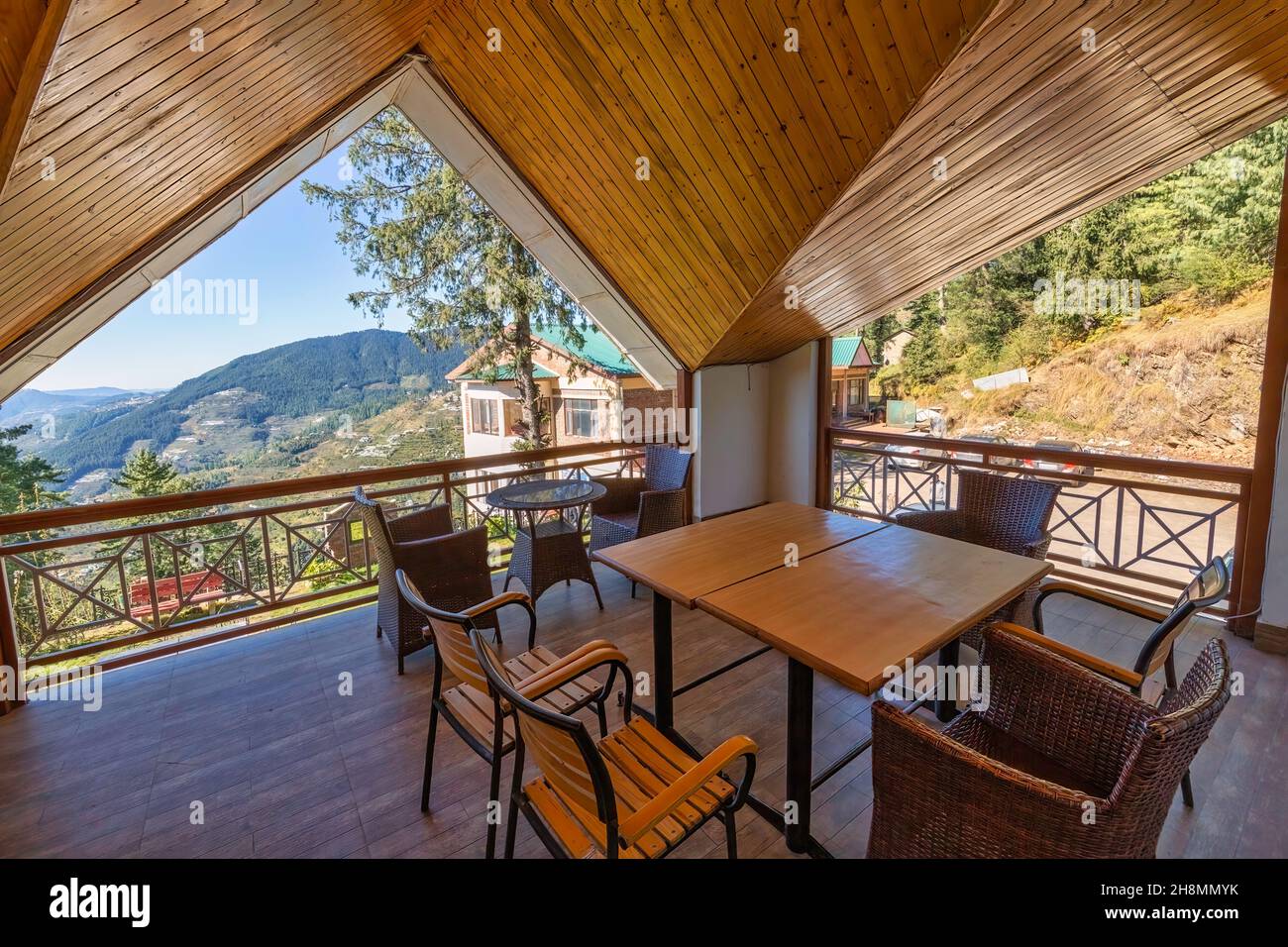 Wooden tourist lodge balcony and sitting area with view of scenic ...