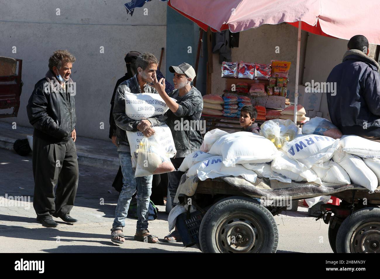 Palestinians receiving food aid for the new cycle from a UN (UNRWA ...
