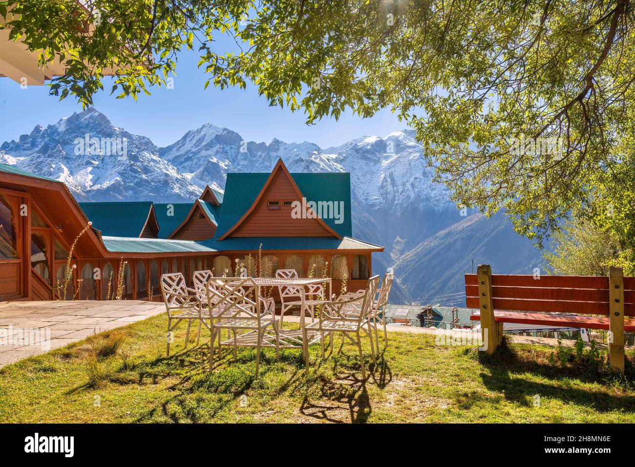 Wooden tourist lodge with view of majestic Kinnaur Kailash Himalaya ...