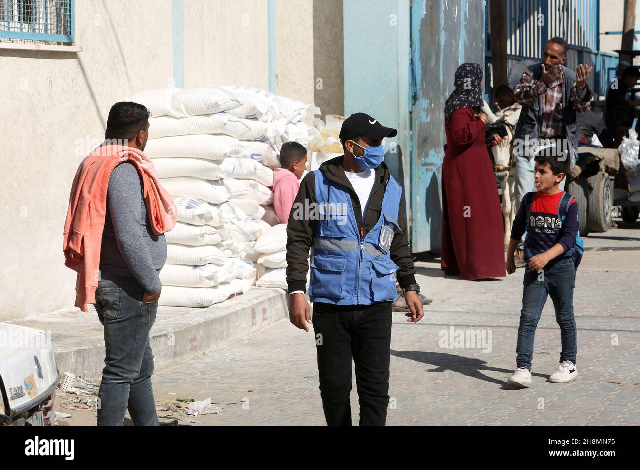Palestinians receiving food aid for the new cycle from a UN (UNRWA ...