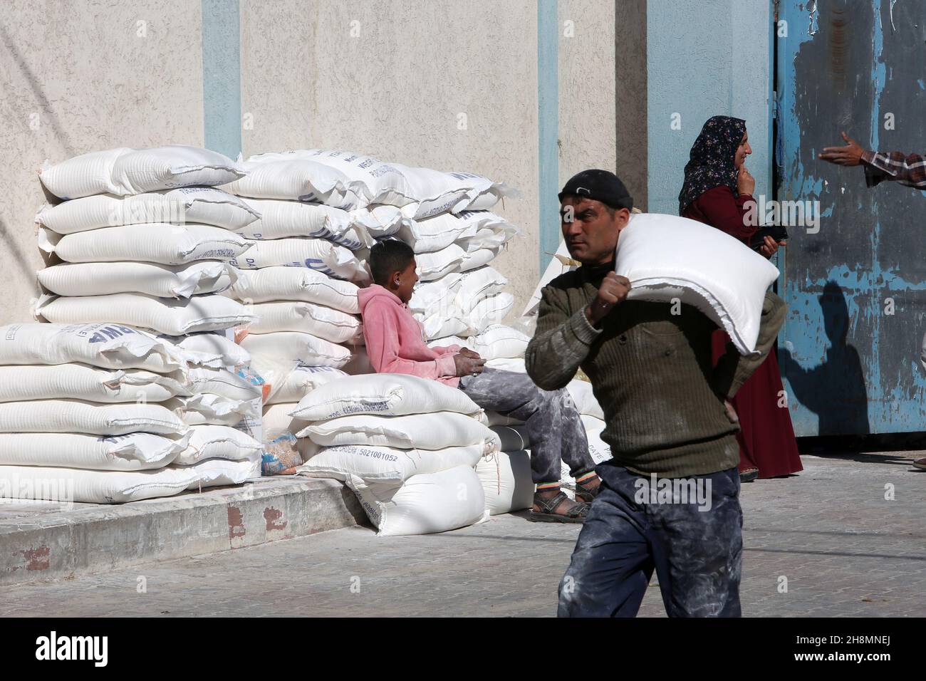 Palestinians receiving food aid for the new cycle from a UN (UNRWA ...