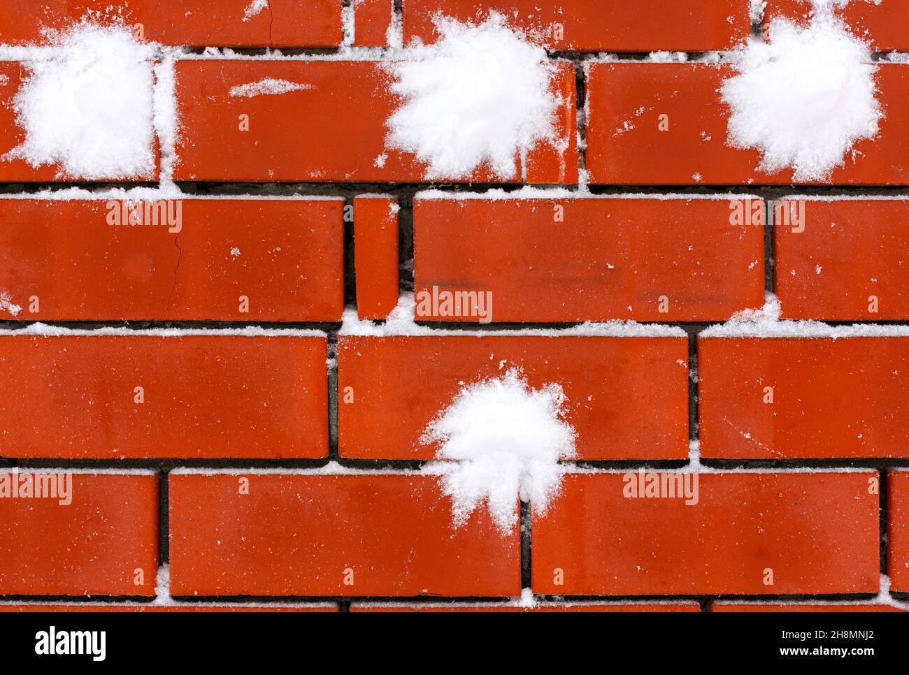 Brick wall with four snowballs on it. Close-up Stock Photo - Alamy