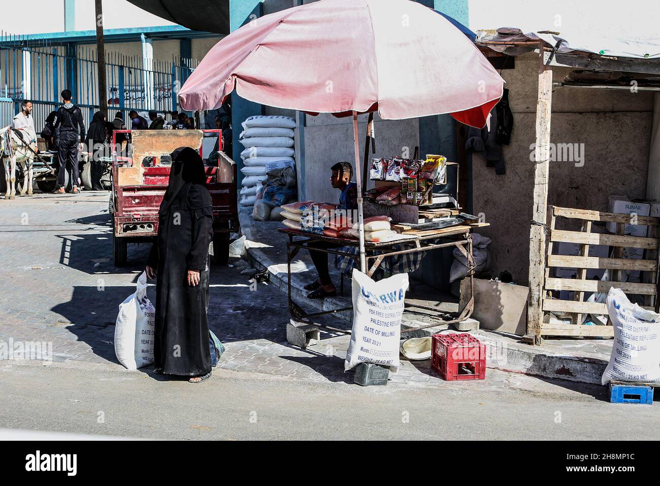 Palestinians receiving food aid for the new cycle from a UN (UNRWA ...