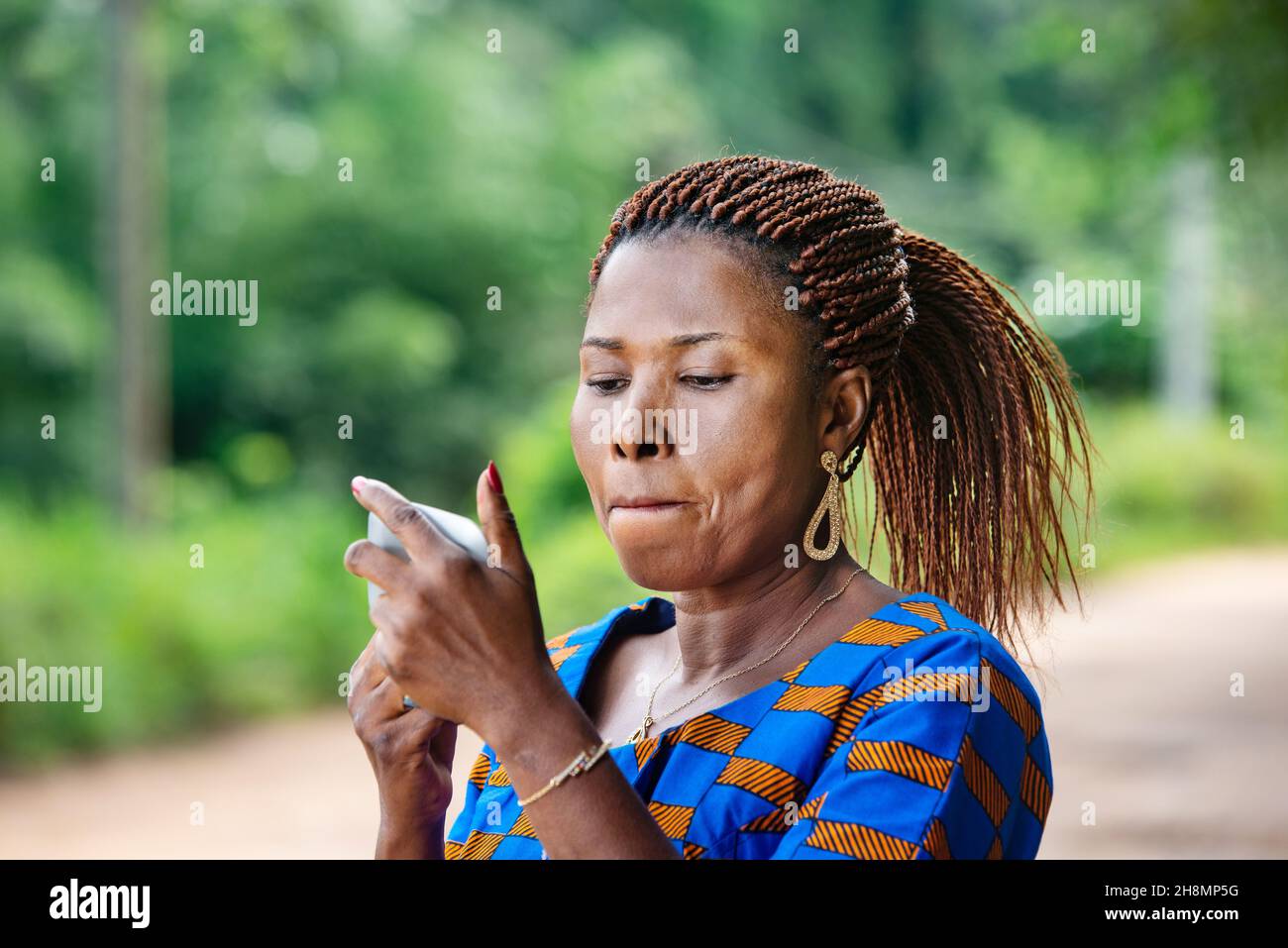 a beautiful African woman in traditional dress standing in the ...