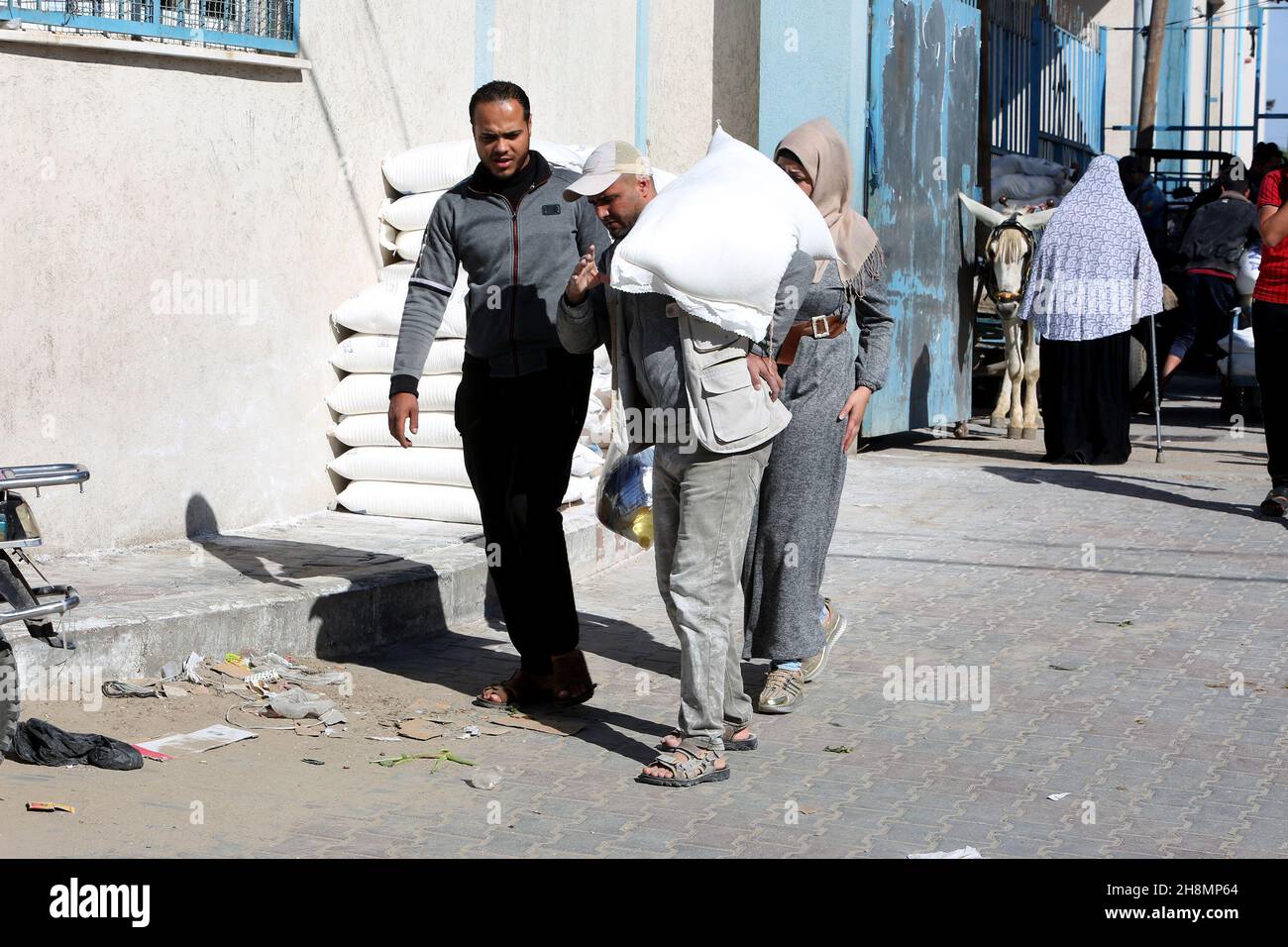 Palestinians receiving food aid for the new cycle from a UN (UNRWA ...
