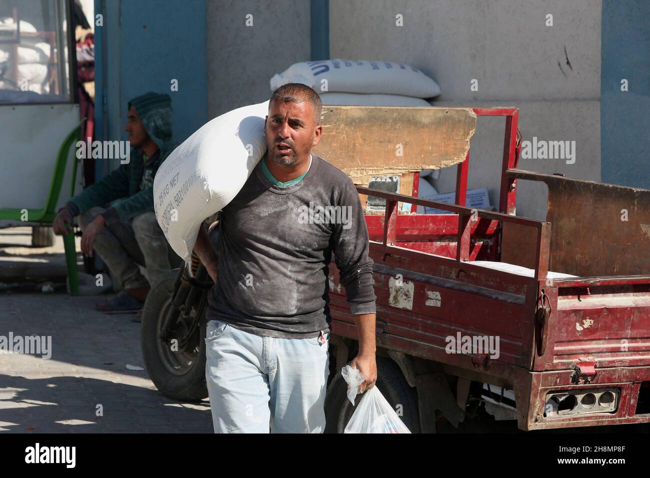 Palestinians receiving food aid for the new cycle from a UN (UNRWA ...