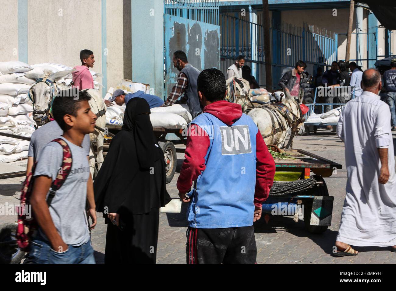 Palestinians receiving food aid for the new cycle from a UN (UNRWA ...
