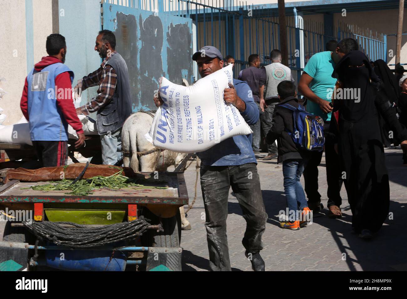 Palestinians receiving food aid for the new cycle from a UN (UNRWA ...