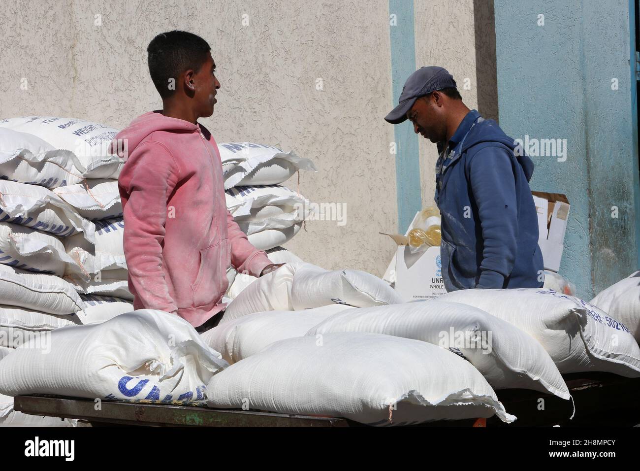 Palestinians receiving food aid for the new cycle from a UN (UNRWA ...