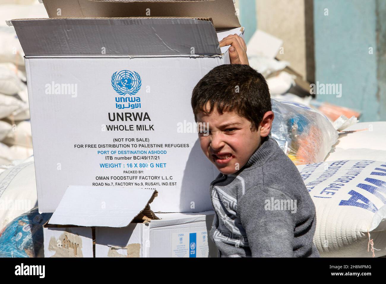 Palestinians receiving food aid for the new cycle from a UN (UNRWA ...