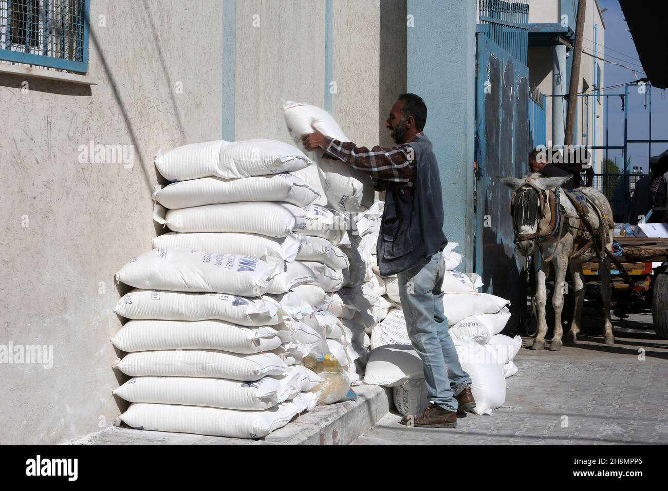 Palestinians receiving food aid for the new cycle from a UN (UNRWA ...