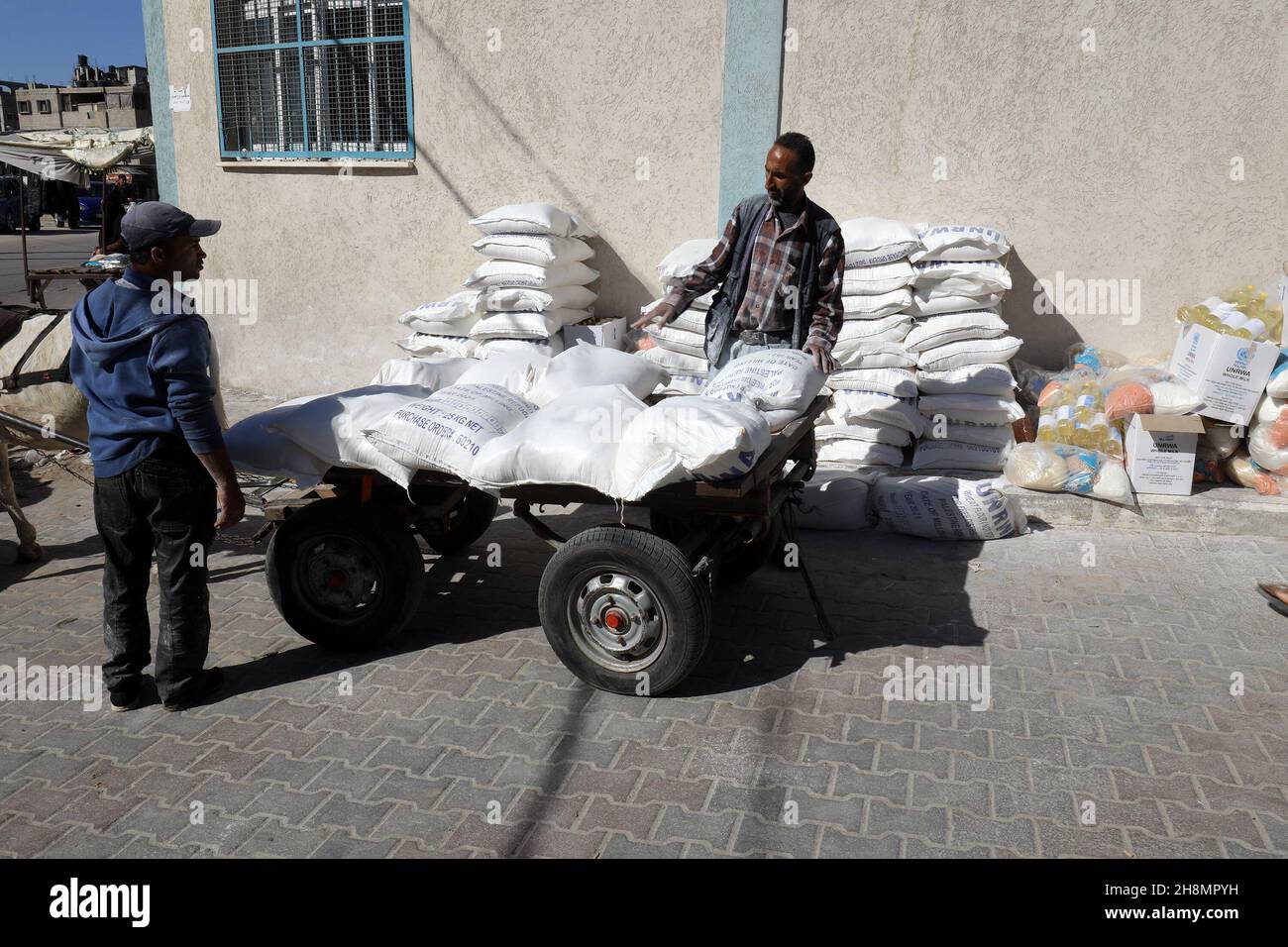 Palestinians receiving food aid for the new cycle from a UN (UNRWA ...