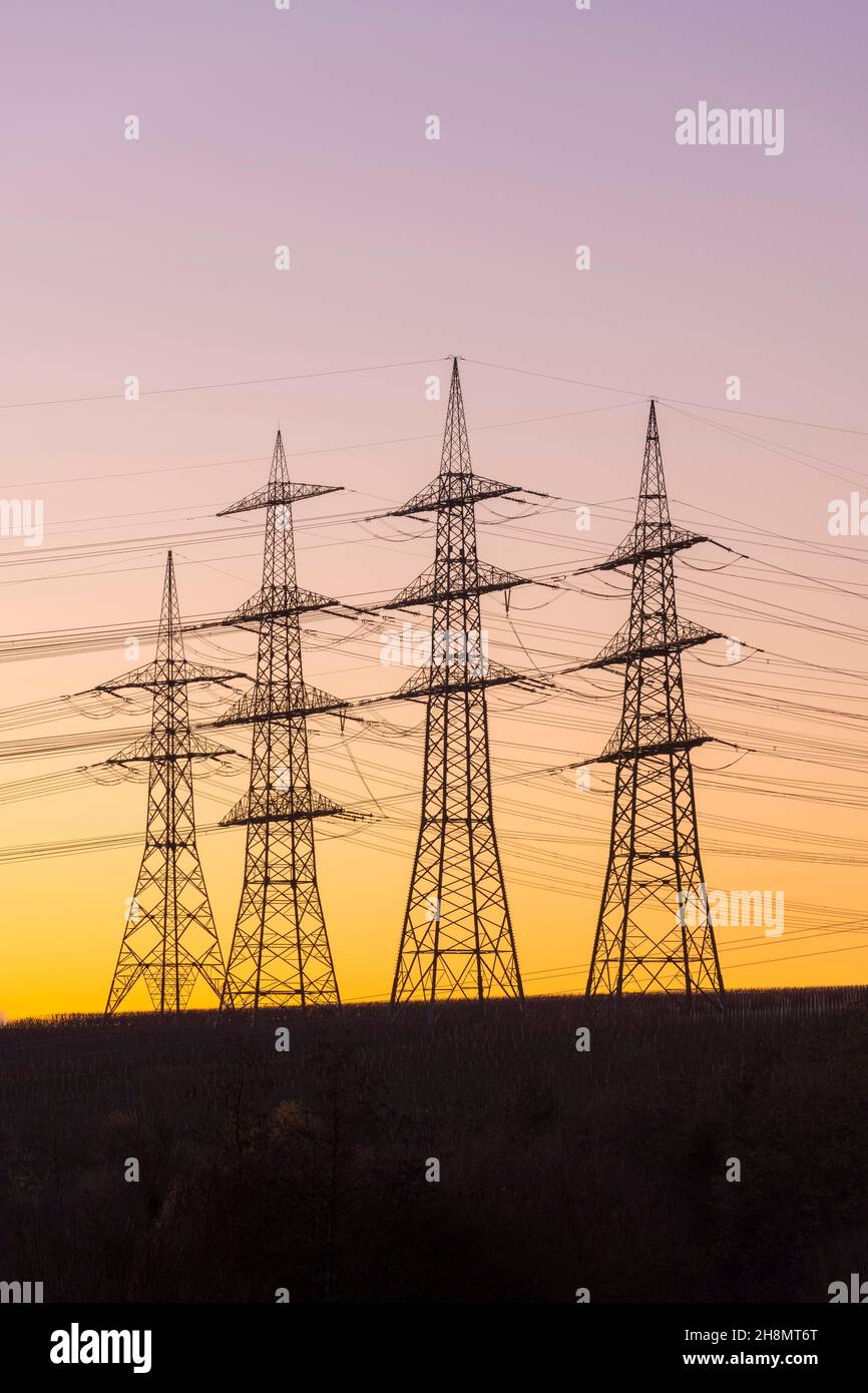 High-voltage pylons, electricity pylons at sunset, Baden-Wuerttemberg ...