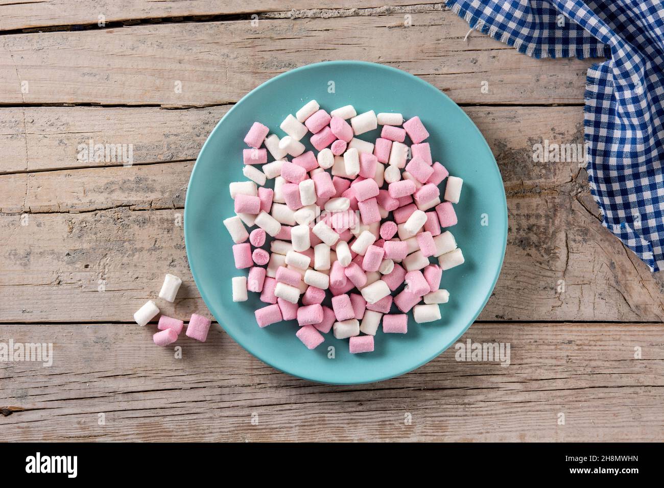 Sweet marshmallows topping in a blue plate on wooden table Stock Photo ...