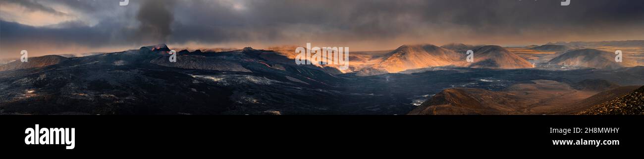 Volcano and lava field, crater with emerging lava and lava flow ...