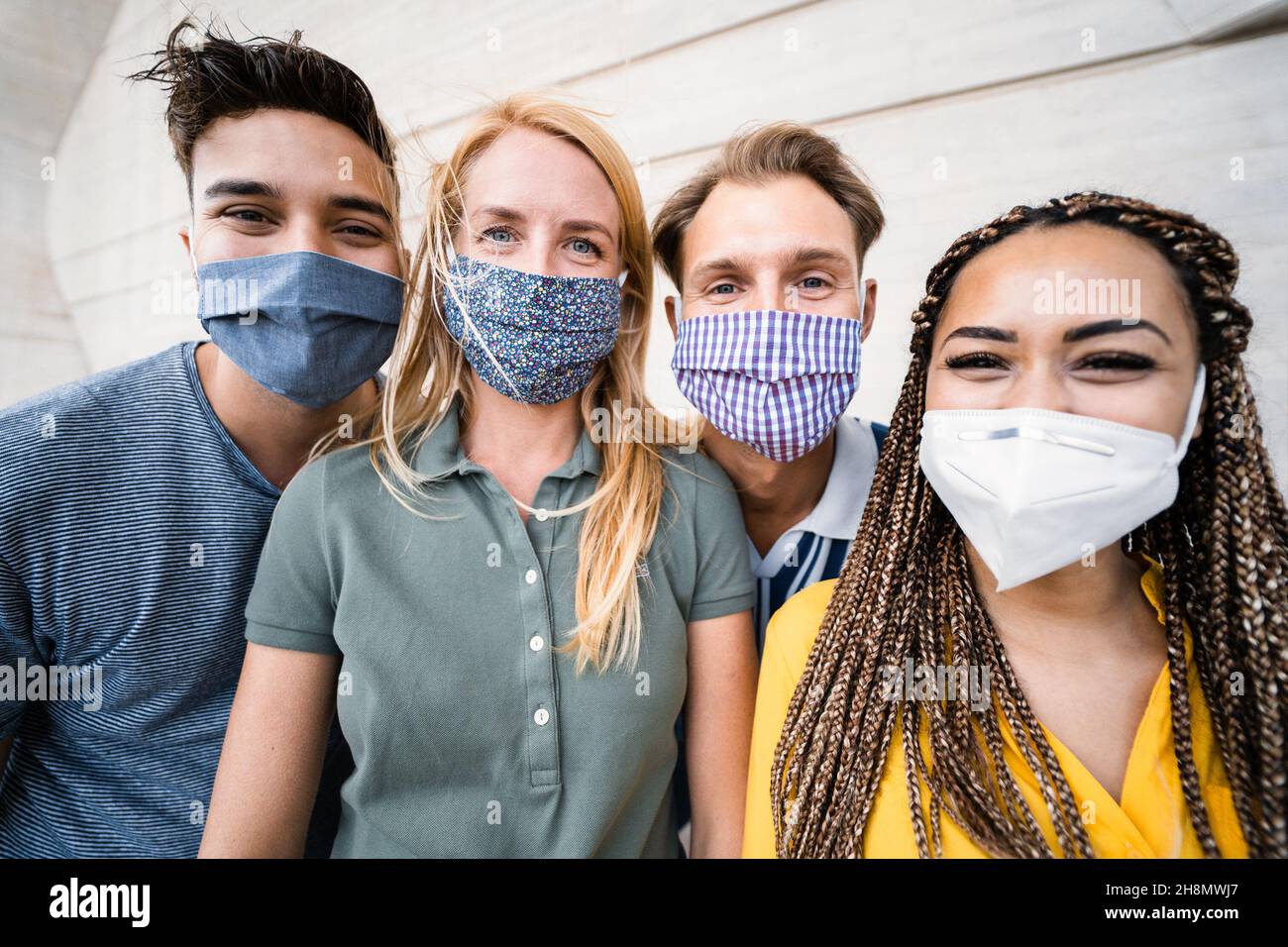 Young multiracial people wearing safety masks during coronavirus ...