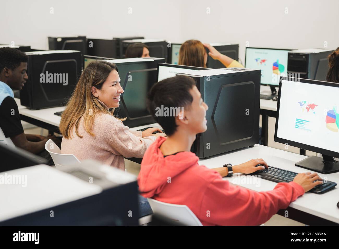 Young students using computers during business class at school - Focus ...