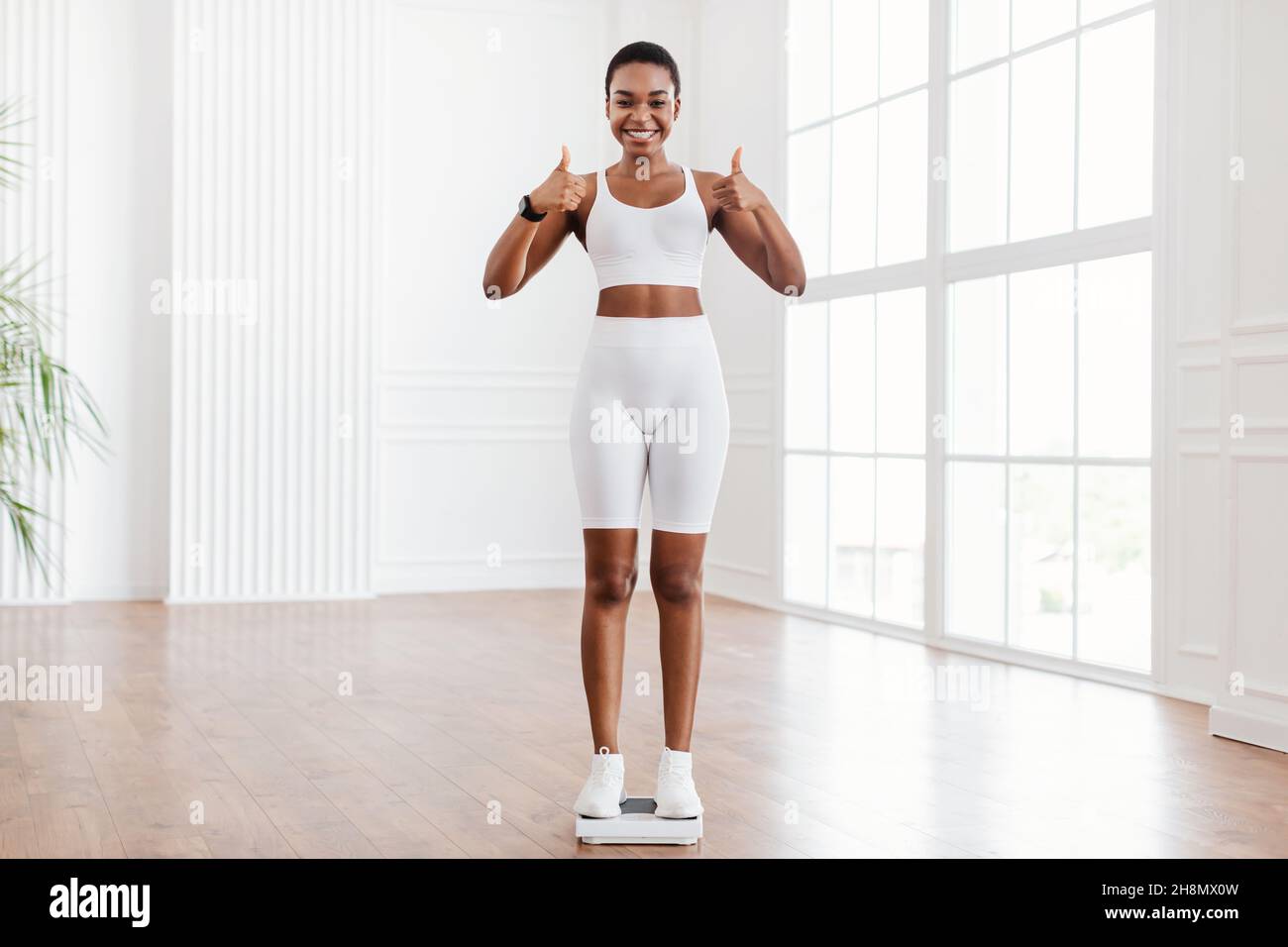 Happy African American Woman Standing On Scales. Slimming Concept Stock ...