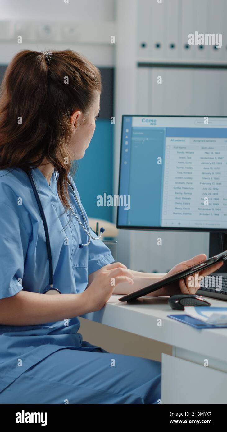 Medical assistant working with computer and digital tablet for ...