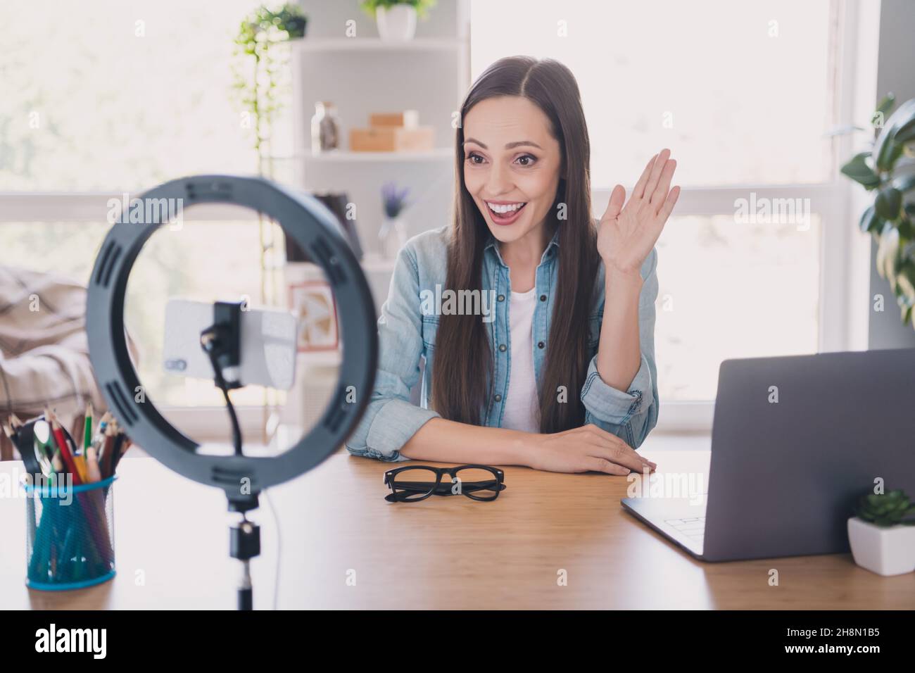 Photo of joyful cool mature positive woman wave hello phone camera ...