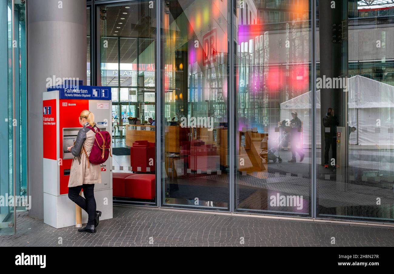 Traveller standing at a Deutsche Bahn ticket machine, Berlin, Germany ...