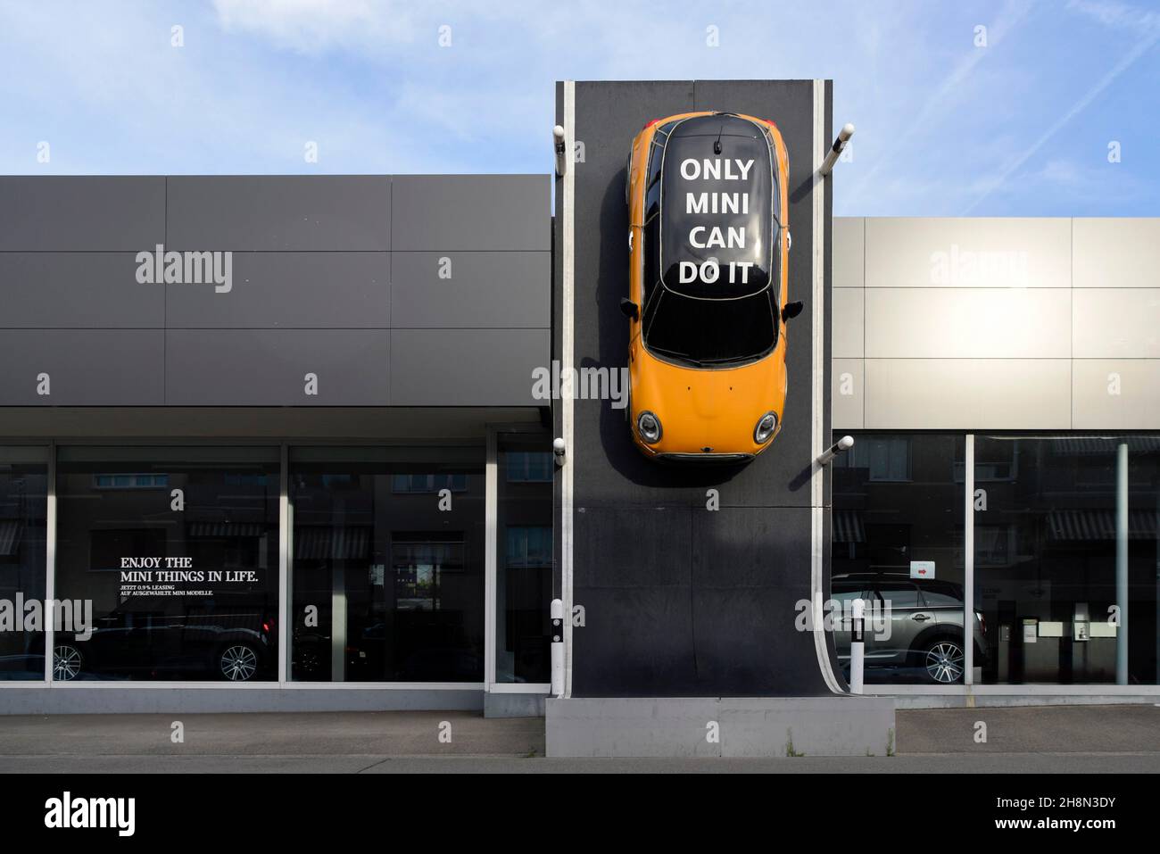 Mini car on building facade, Switzerland Stock Photo - Alamy