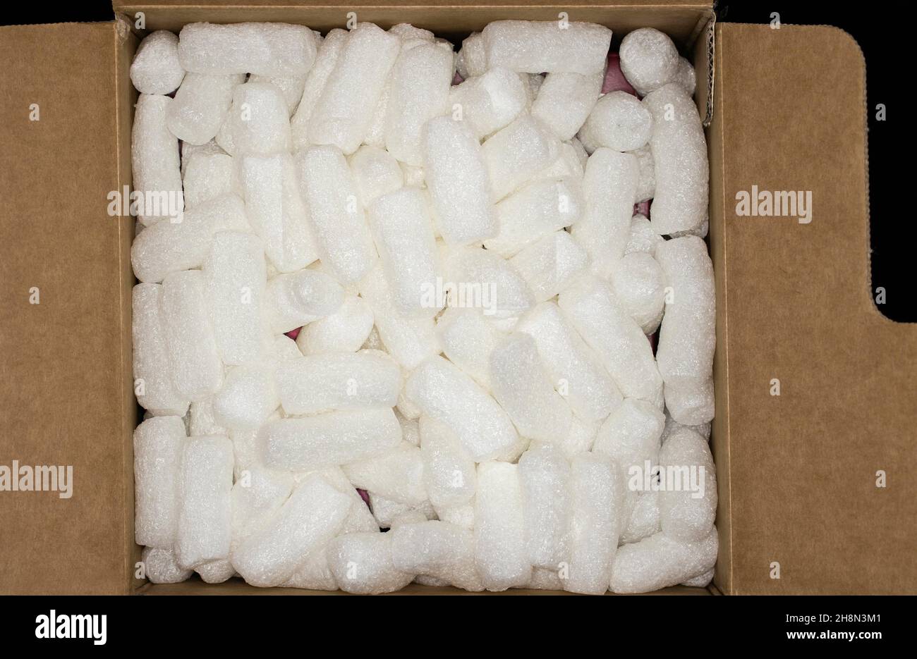 Biodegradable cornflakes as a filler in a cardboard box, studio ...