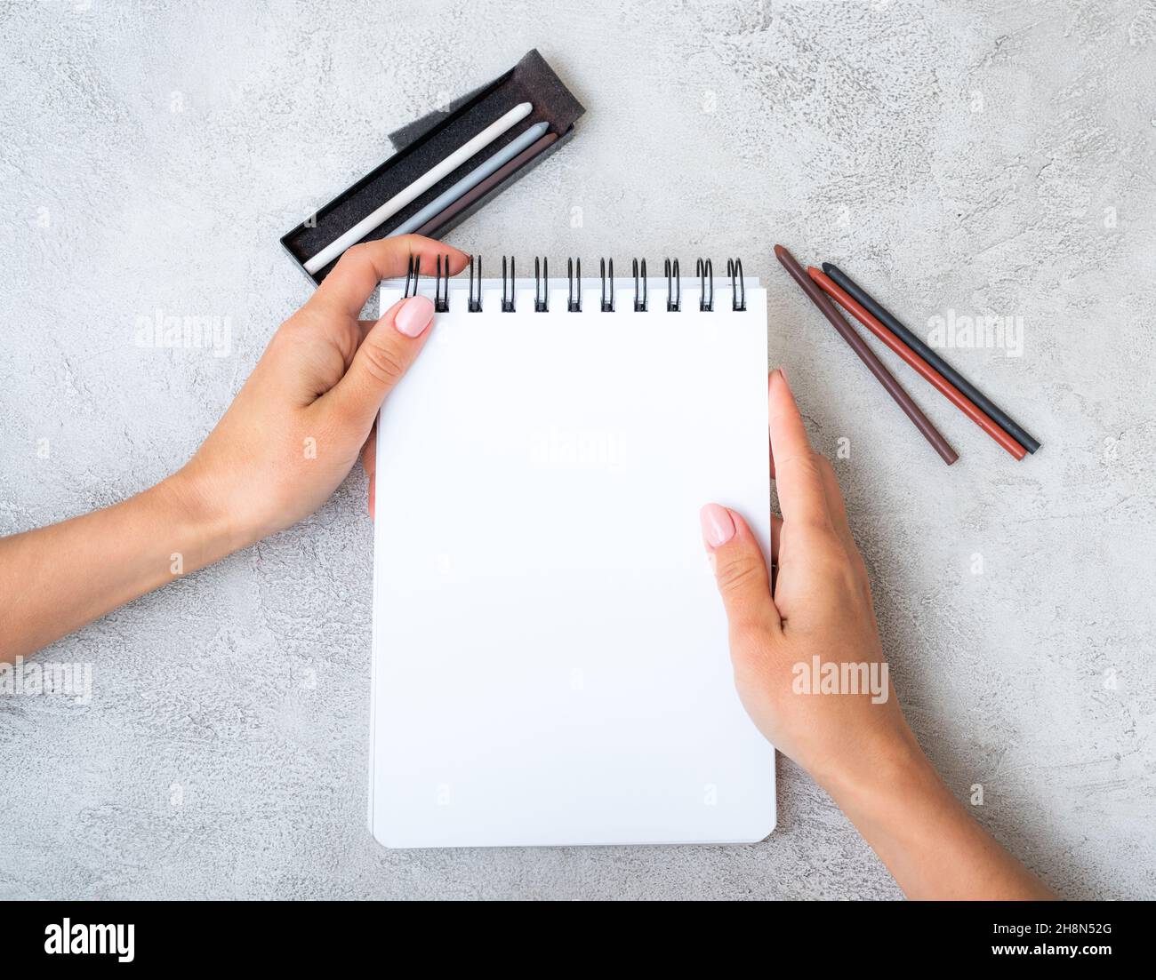 Girl's hands holding notebook Stock Photo - Alamy