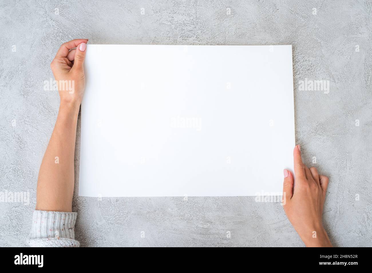 Girl's holding a paper Stock Photo - Alamy