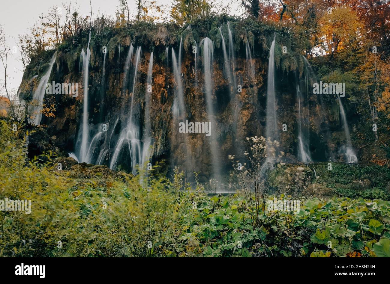 Stunning view of foamy waterfall at famous Plitvice Lakes National Park ...