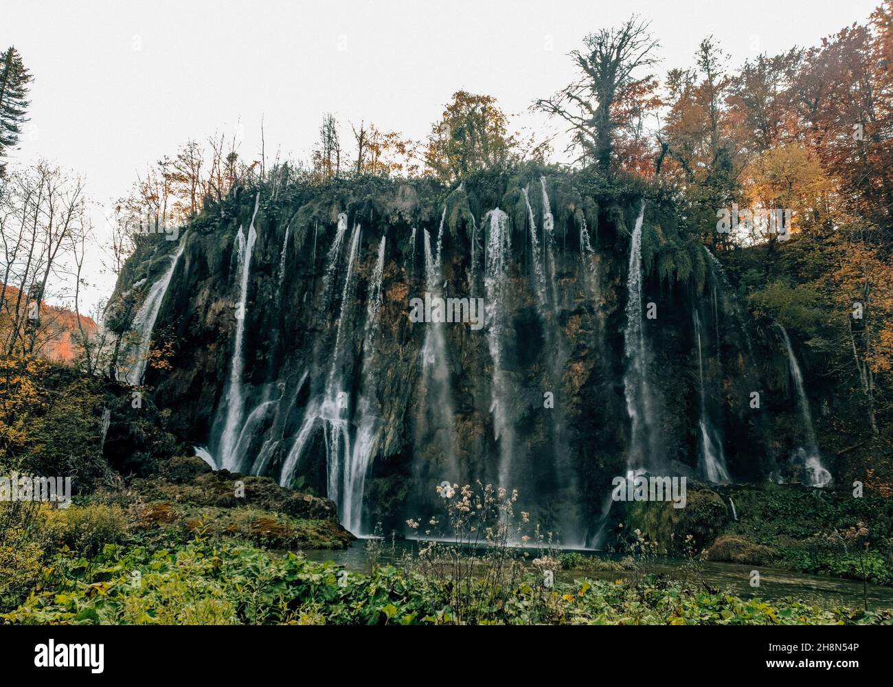 Stunning view of foamy waterfall at famous Plitvice Lakes National Park ...