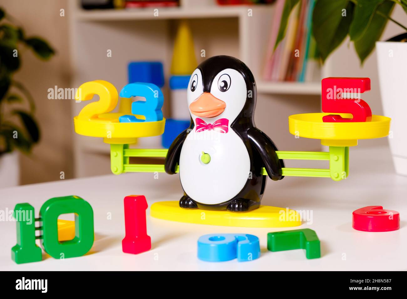 The penguin scale weighs the numbers, the math for the kids Stock Photo ...