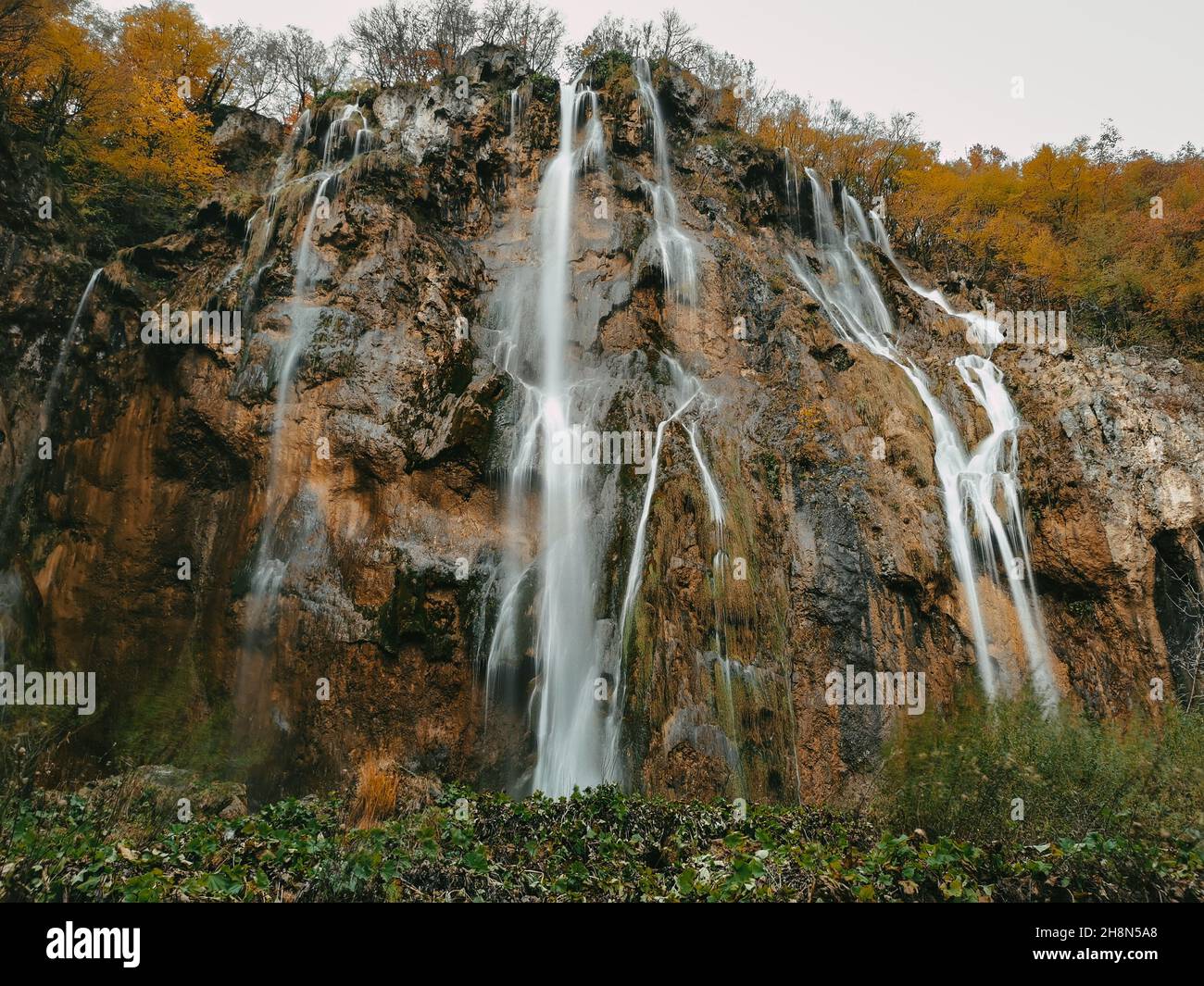 Stunning view of foamy waterfall at famous Plitvice Lakes National Park ...