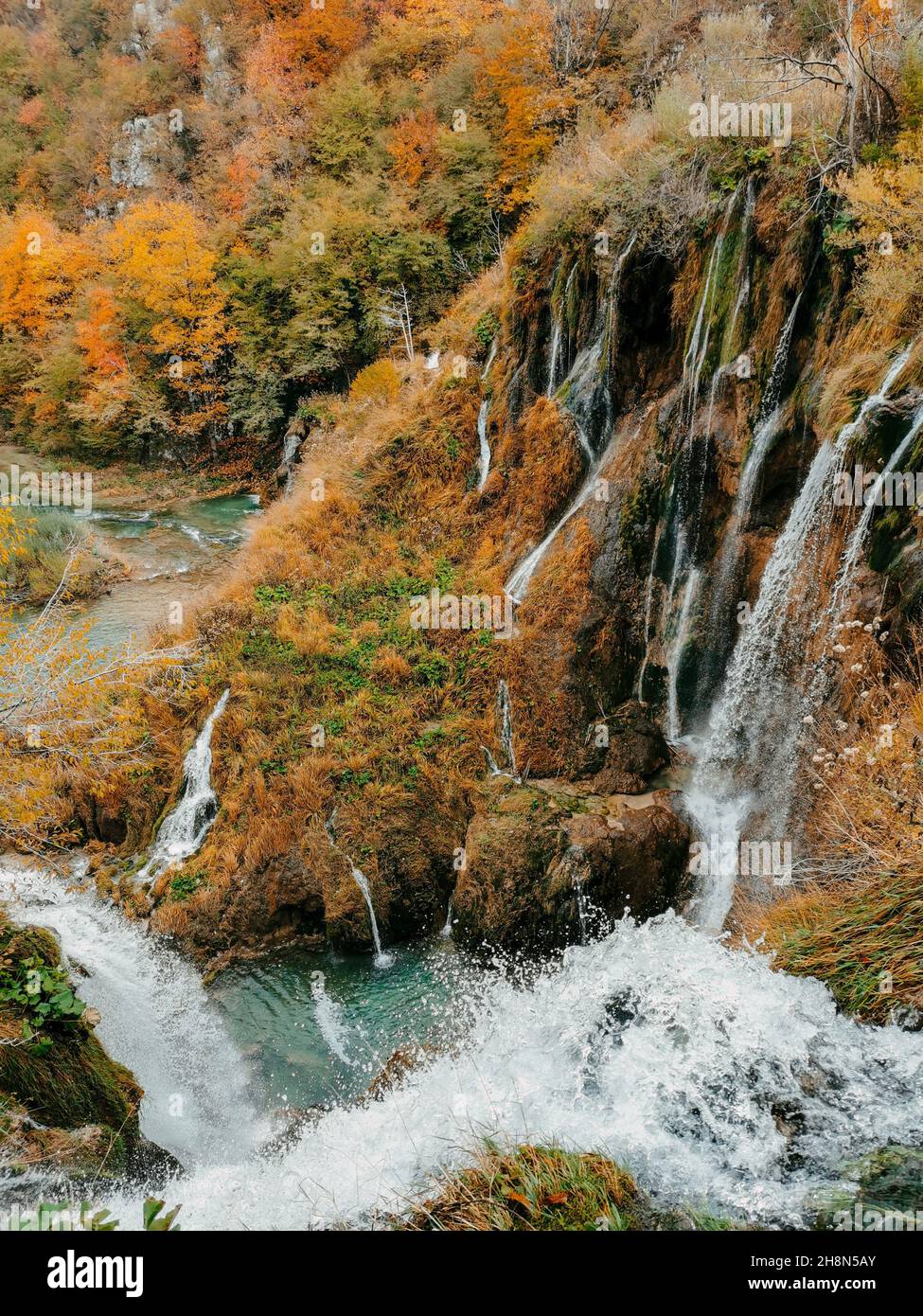 Stunning view of foamy waterfall at famous Plitvice Lakes National Park ...