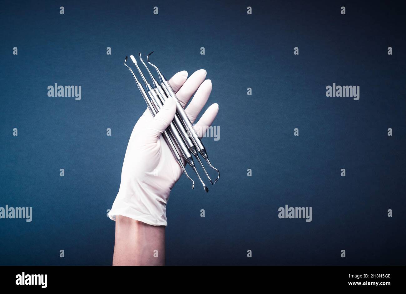 Hand in glove holding medical tools Stock Photo - Alamy
