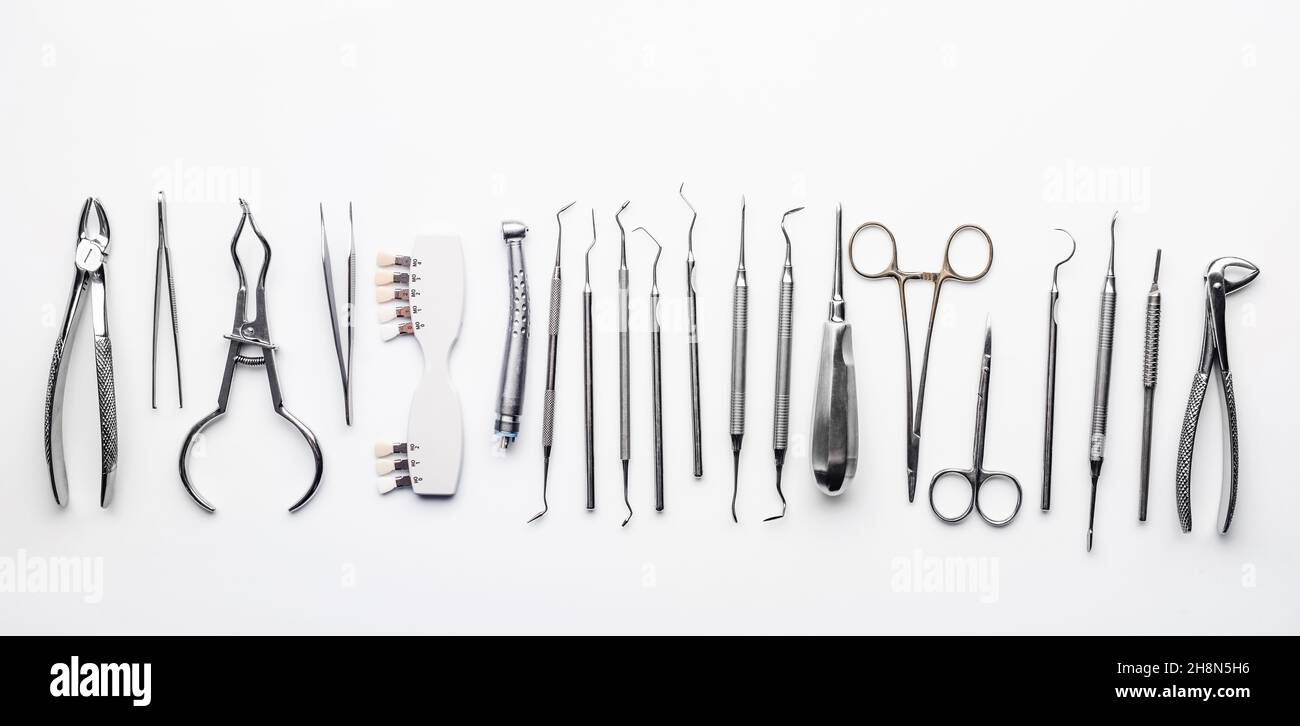 Dental tools on white table Stock Photo - Alamy