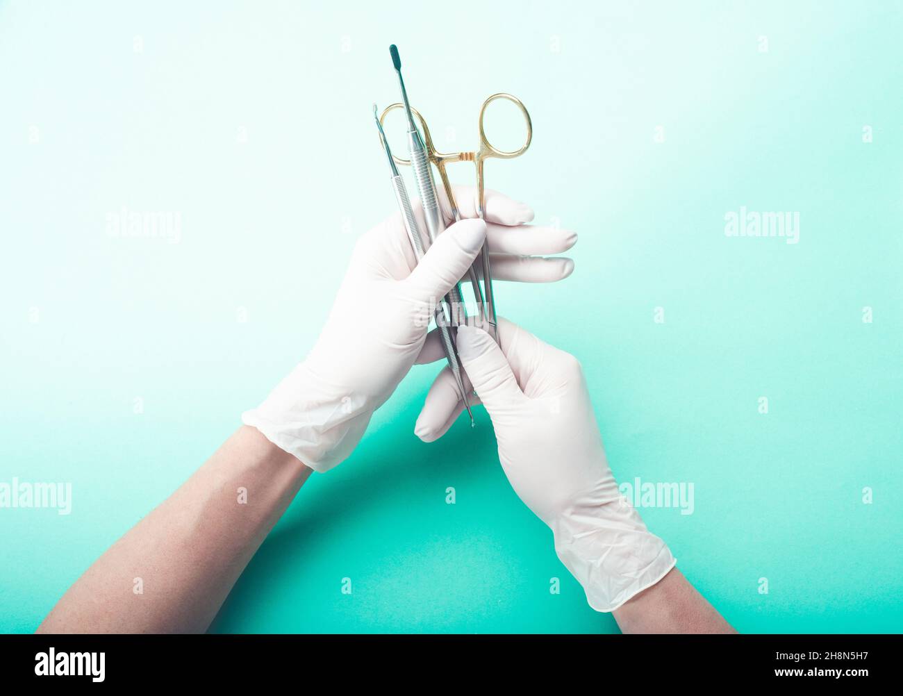 Hands in gloves holding medical tools Stock Photo - Alamy