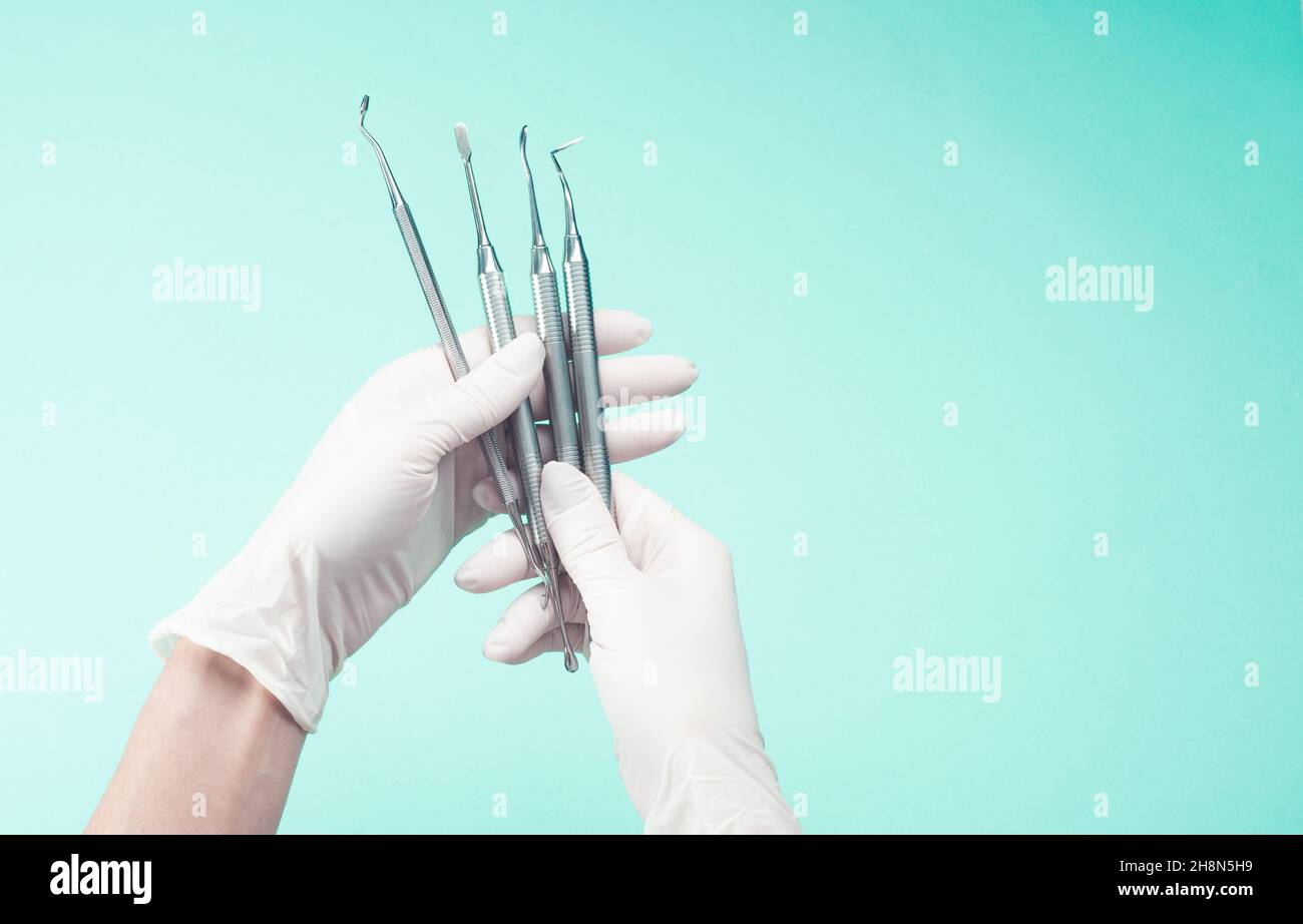 Hands in gloves holding medical tools Stock Photo - Alamy