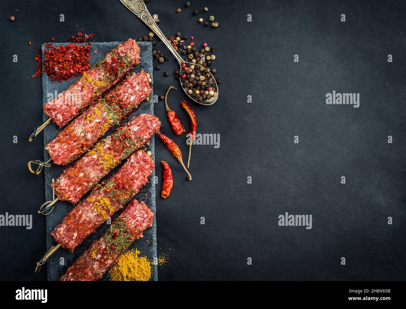 Raw kebab with spices Stock Photo - Alamy